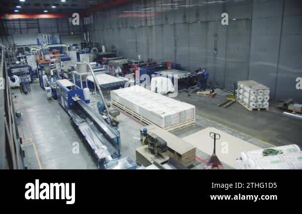 Specialists walk near stacks of monolithic polycarbonate sheets in ...
