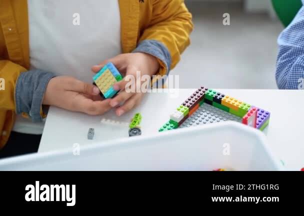 Robotics programming class. Children construct and code Robot. STEM education using constructor ...