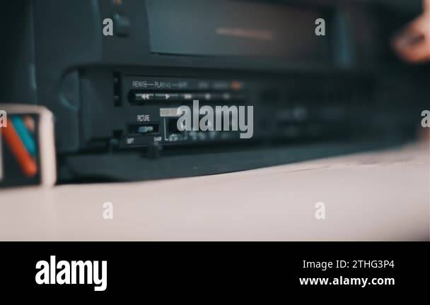 Female hand pulls out VHS from a vintage videotape recorder. Eject VHS ...