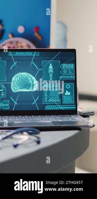 Vertical video: Empty desk with brain x ray on laptop running ...