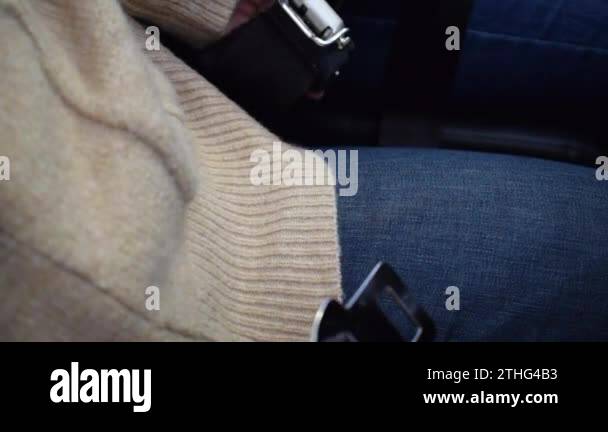 Female passenger fastening seatbelt in commercial airplane before take ...