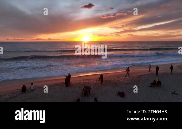 Beautiful sea sunset background, crowd of happy cheerful friends ...