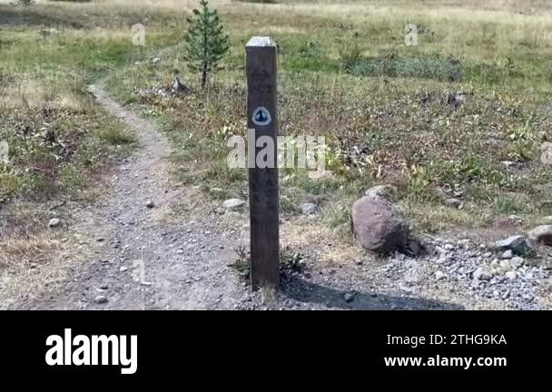 Point of View (POV) of hiker walking up to a Pacific Crest Trail marker ...
