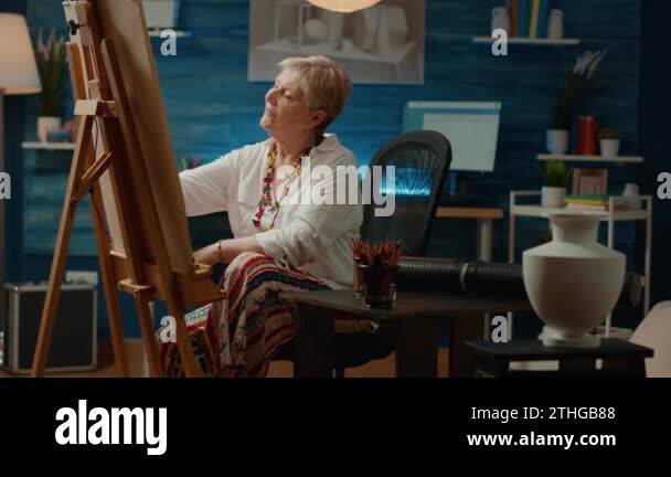 Senior person drawing masterpiece with authentic model, creating ...