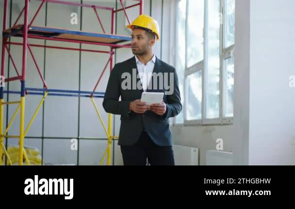 Man architect looking carefully around in the construction site ...