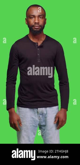 Vertical video: Front view of young male model feeling stylish posing ...