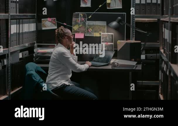 Law officer checking forensic evidence in police office, looking at ...
