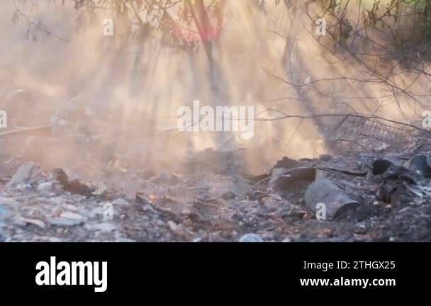 Solid waste being heaped fire burn garbage waste plastic, smoke ... Solid waste being heaped fire burn garbage waste plastic, smoke ...