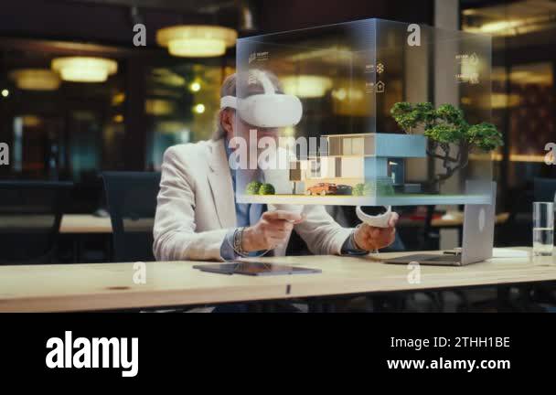 Male designer uses VR headset and wireless controllers, makes ...