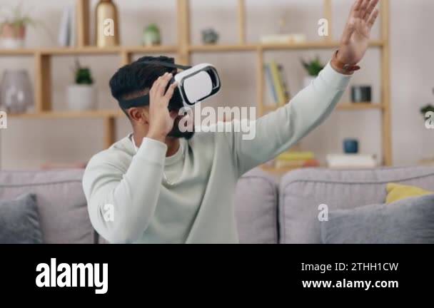 Virtual reality, metaverse and man in the living room with a headset ...