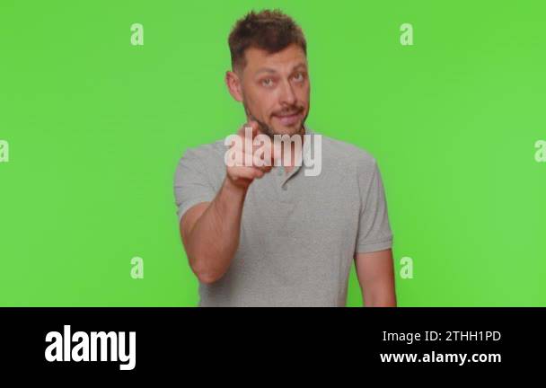 Hey you. Bearded handsome young man smiling excitedly and pointing to ...