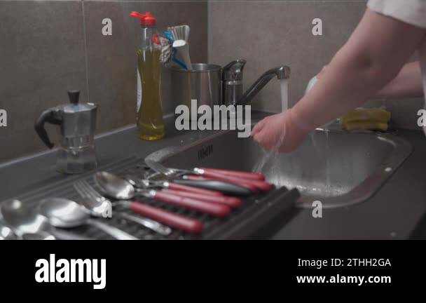 House cleaning, household chores. Washing dishes and kitchen utensils ...