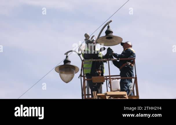 fix light, crane lifted, aerial device. Street light repair works are ...