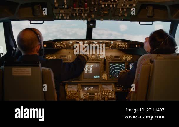 Pilot and woman copilot fixing altitude and longitude on dashboard ...