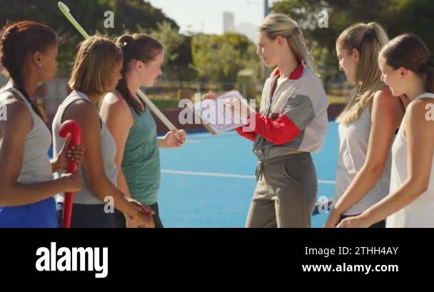 Hockey coach planning a strategy and positions with a group of teenage ...