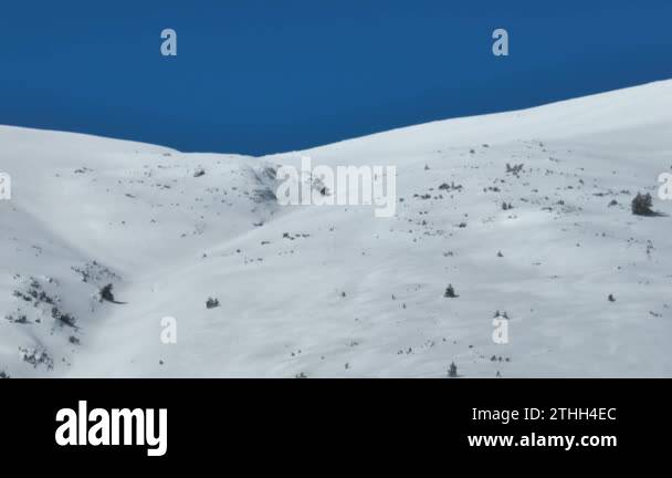 Cinematic Aerial downhill freeride skiing in fresh deep snow with ...