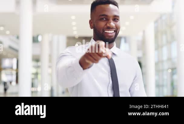 Happy young businessman pointing at you in a modern office. Smiling ...