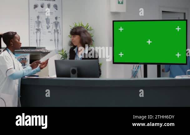 Waiting area and reception desk with greenscreen on tv display ...