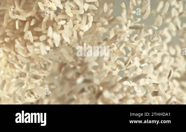 Rice soars up and rotates in flight. Top view. Filmed is slow motion ...