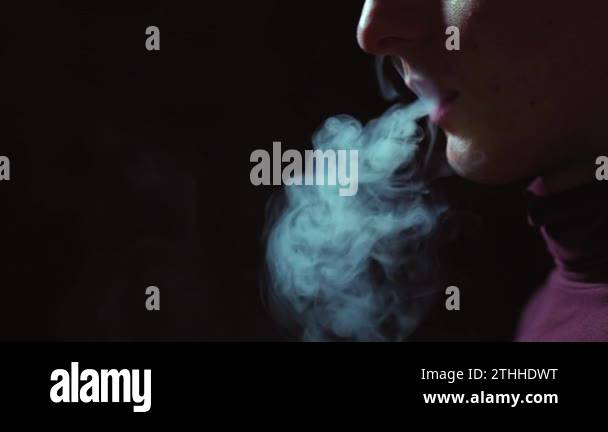 Electric device for smoking. A man smokes an electronic cigarette in ...