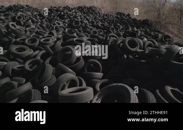 This striking top-down view captures a massive dump of car tires ...