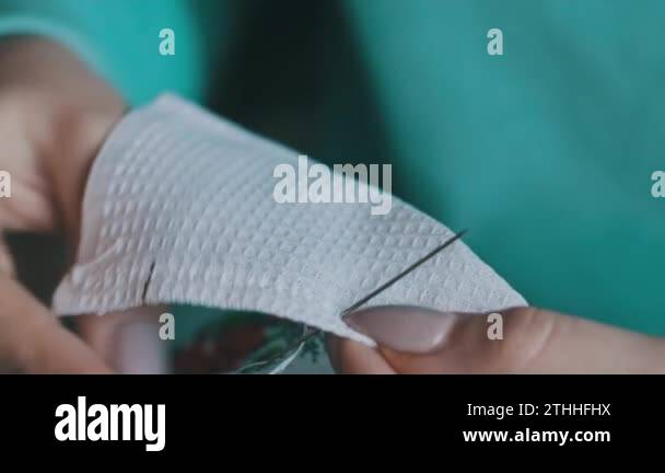 Beautiful female hands sew manually with thread and needle. Young woman ...