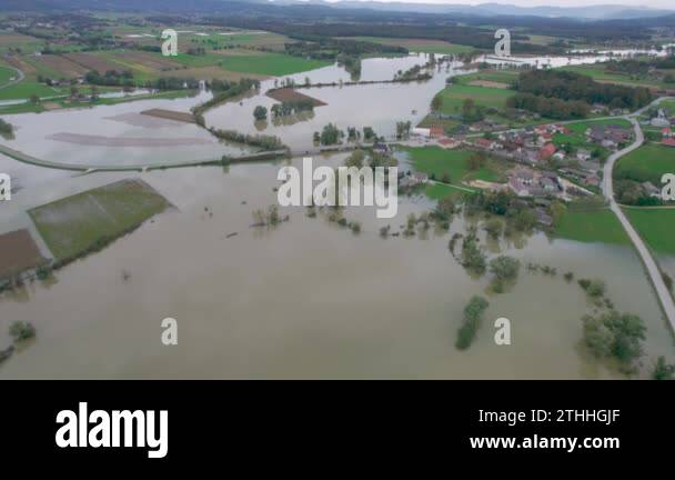 AERIAL: Extensive flooding of farmland after a rising river overflowed its banks. Muddy autumn ...