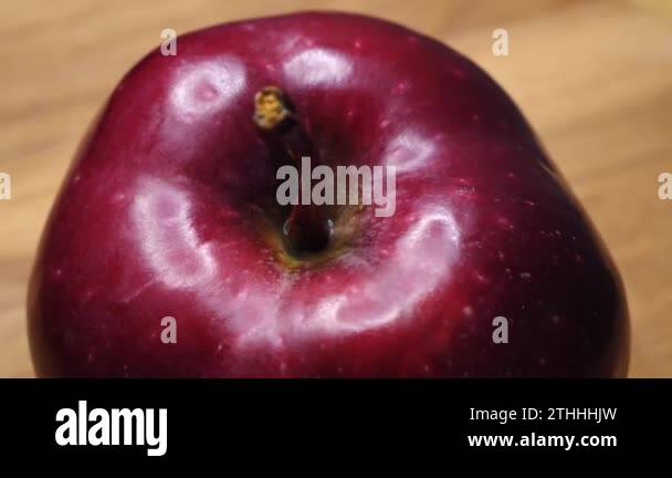 Single red apple close-up. An apple of the red chief variety rotates in ...