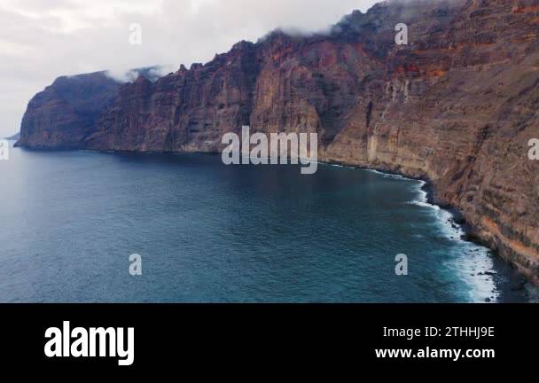 Aerial view of Los Gigantes cliffs, Tenerife. Flight over huge rocks ...