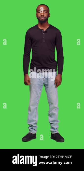 Vertical video: Front view of african american person smiling in studio ...