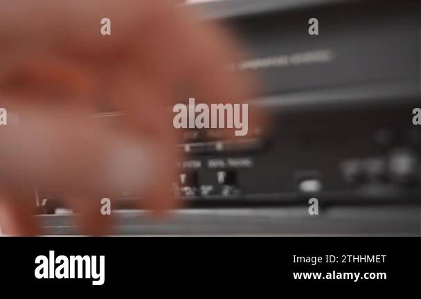 Male hand pulls out VHS from a vintage videotape recorder. Eject VHS ...