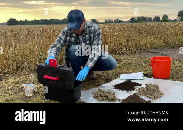 Agronomy scientist preparing soil analysis, opening equipment box ...