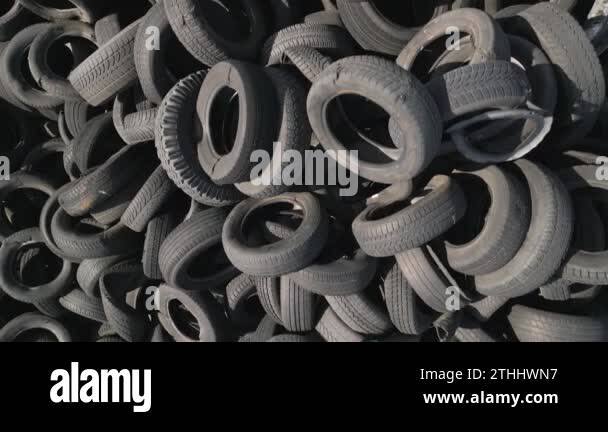 This striking top-down view captures a massive dump of car tires ...