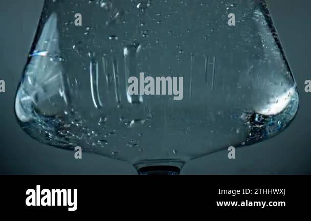 Air bubbles rising glass surface closeup. Fizzy drink bubbling transparent cup. Mineral soda ...