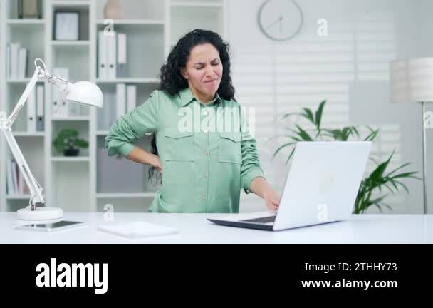 Overworked tired employee businesswoman with severe back pain after ...