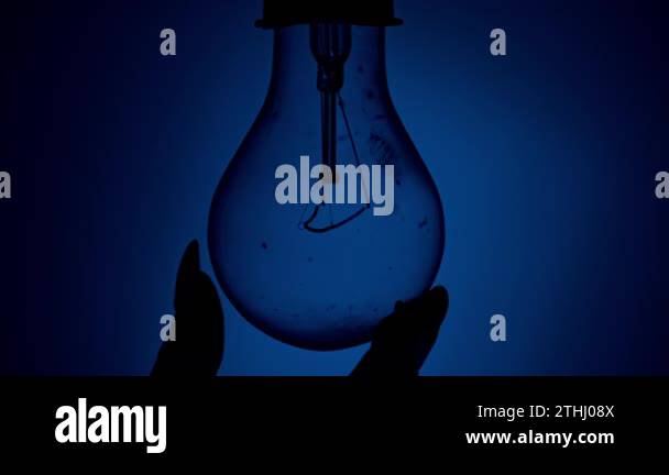 Light bulb turns on and goes out at the touch of a persons hand in the ...