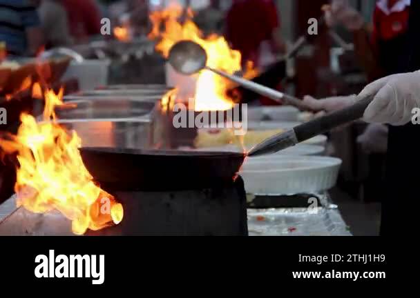 Chef Cooking A Stir-Fried Dish In Flaming Pan. Chef Flambe Cooking ...