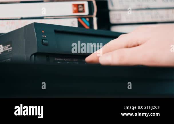 Male hand pulls out VHS from a vintage videotape recorder. Eject VHS ...