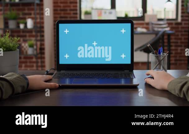 POV of startup manager typing on laptop with greenscreen in brick wall office. Using isolated ...