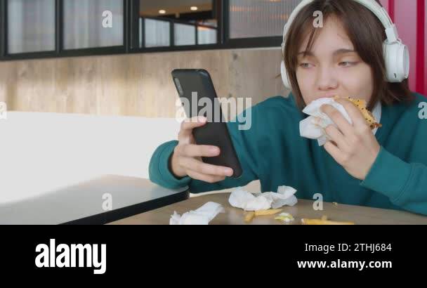 Harmful effects of unhealthy food and digital addiction. Teenage girl ...