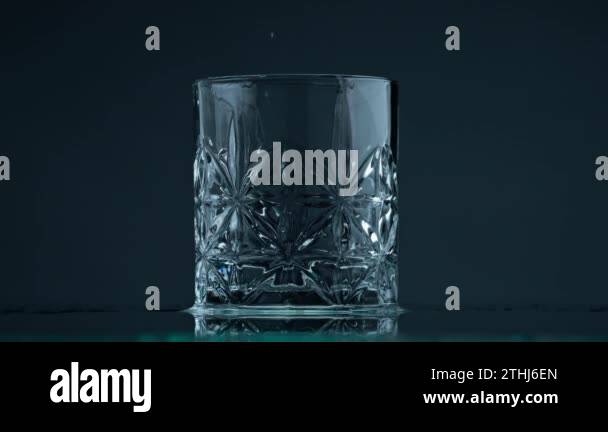 Drinking water rippling glass closeup. Crystal clear droplets falling ...