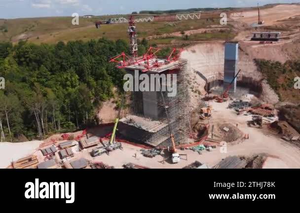 Road bridge support building with scaffold and tower crane on ...