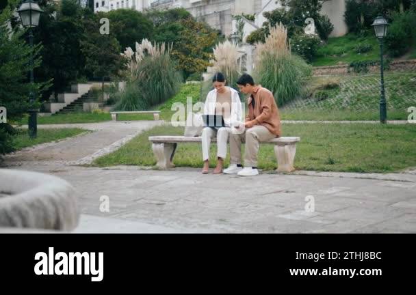 College students learning tablet on bench. Inspired young business ...