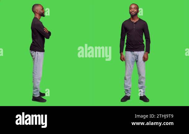 Friendly casual person posing over full body greenscreen backdrop ...