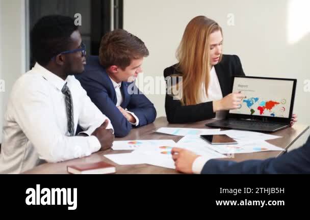 Business woman shows a presentation with charts, diagrams on laptop for ...