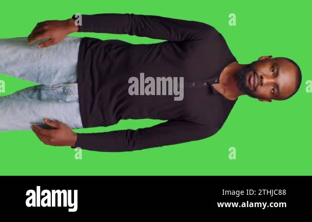 Vertical video: Front view of young male model feeling stylish posing ...