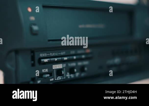 Insert VHS cassette into VCR player. Black vintage videotape cassette ...