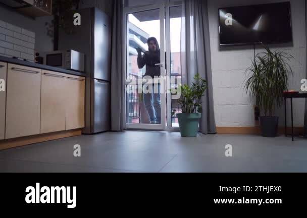 Burglar robber break door lock and entering building apartment. house ...