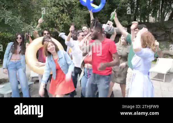 Multicultural group friends having fun at pool kiosk bar caf dancing ...