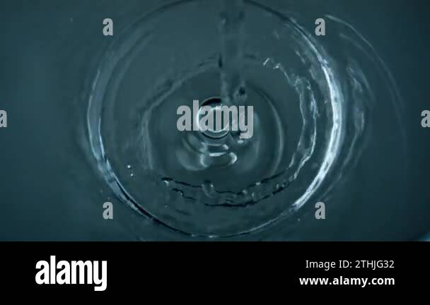 Pure water filling glass top view closeup. Crystal clear liquid stream ...